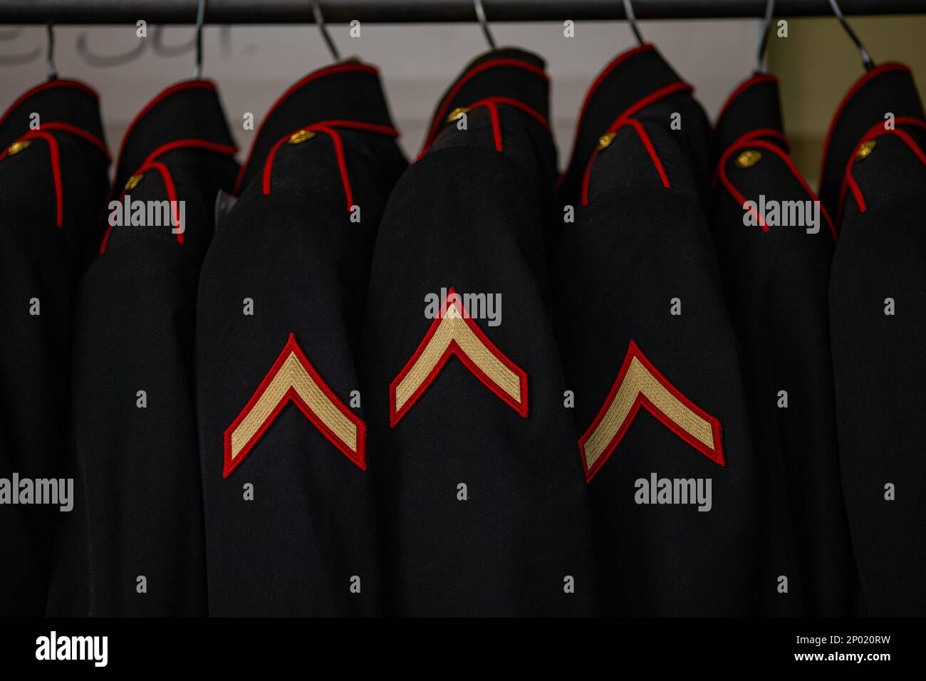 U.S. Marine Corps Dress Blue coats are hung in preparation to be ...