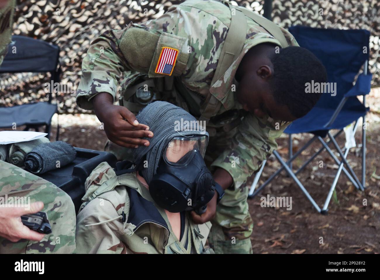 A Soldier assigned to the 3rd Infantry Division treats a head injury on ...