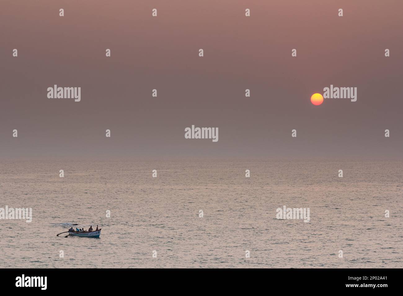 Fishermen fishing in the sea at sunset off Palolem Beach in Goa, India ...