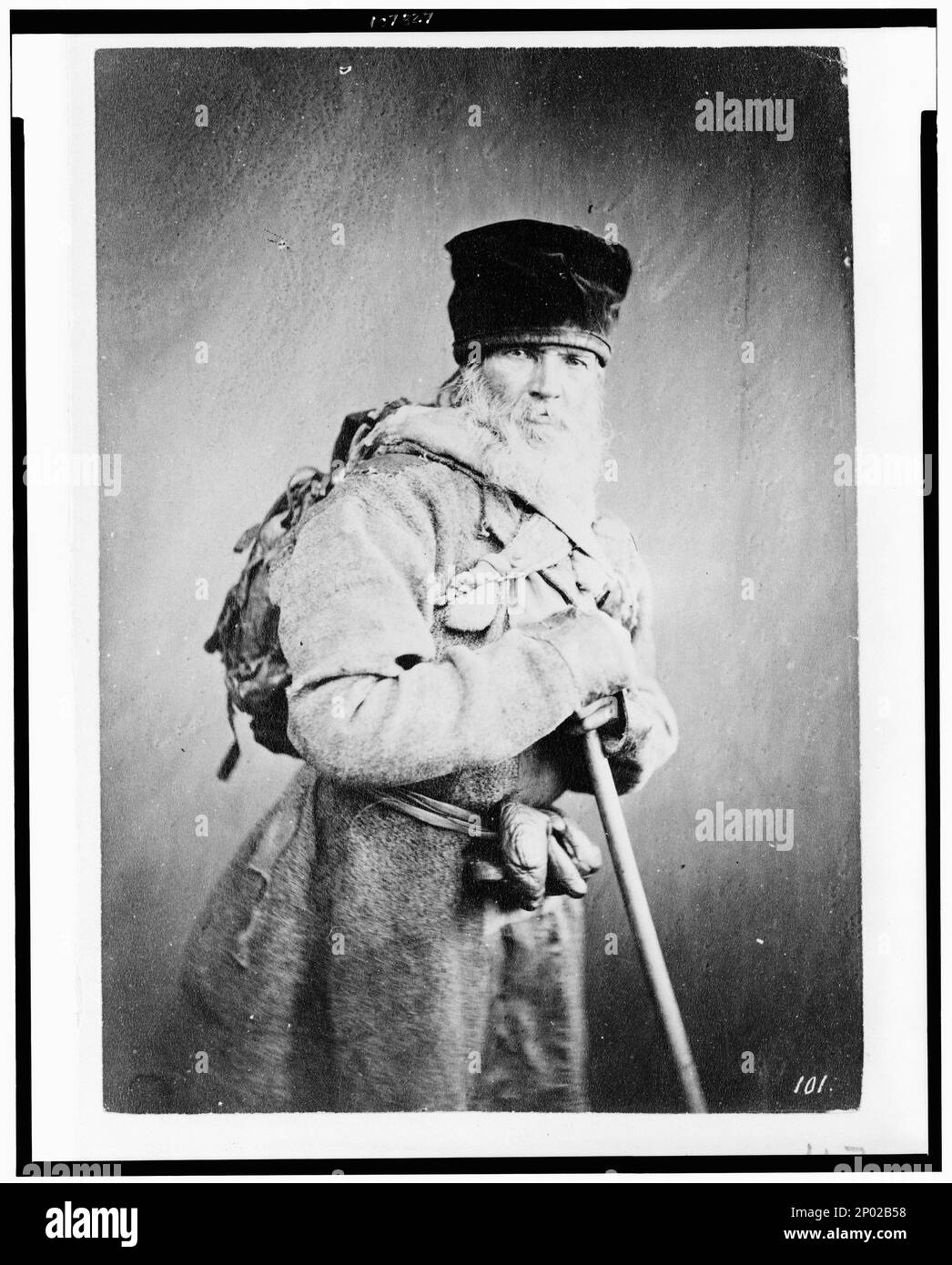 Bearded man, standing, three-quarter length, wearing backpack, with ...