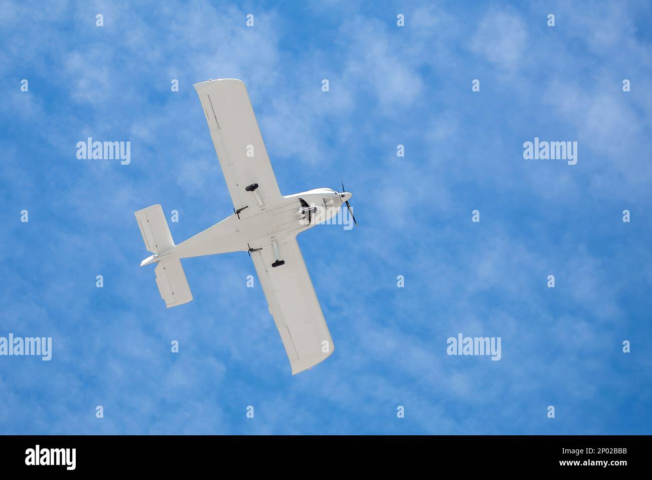 Ground view of a small white plane flying in Turkey. Small aircraft ...