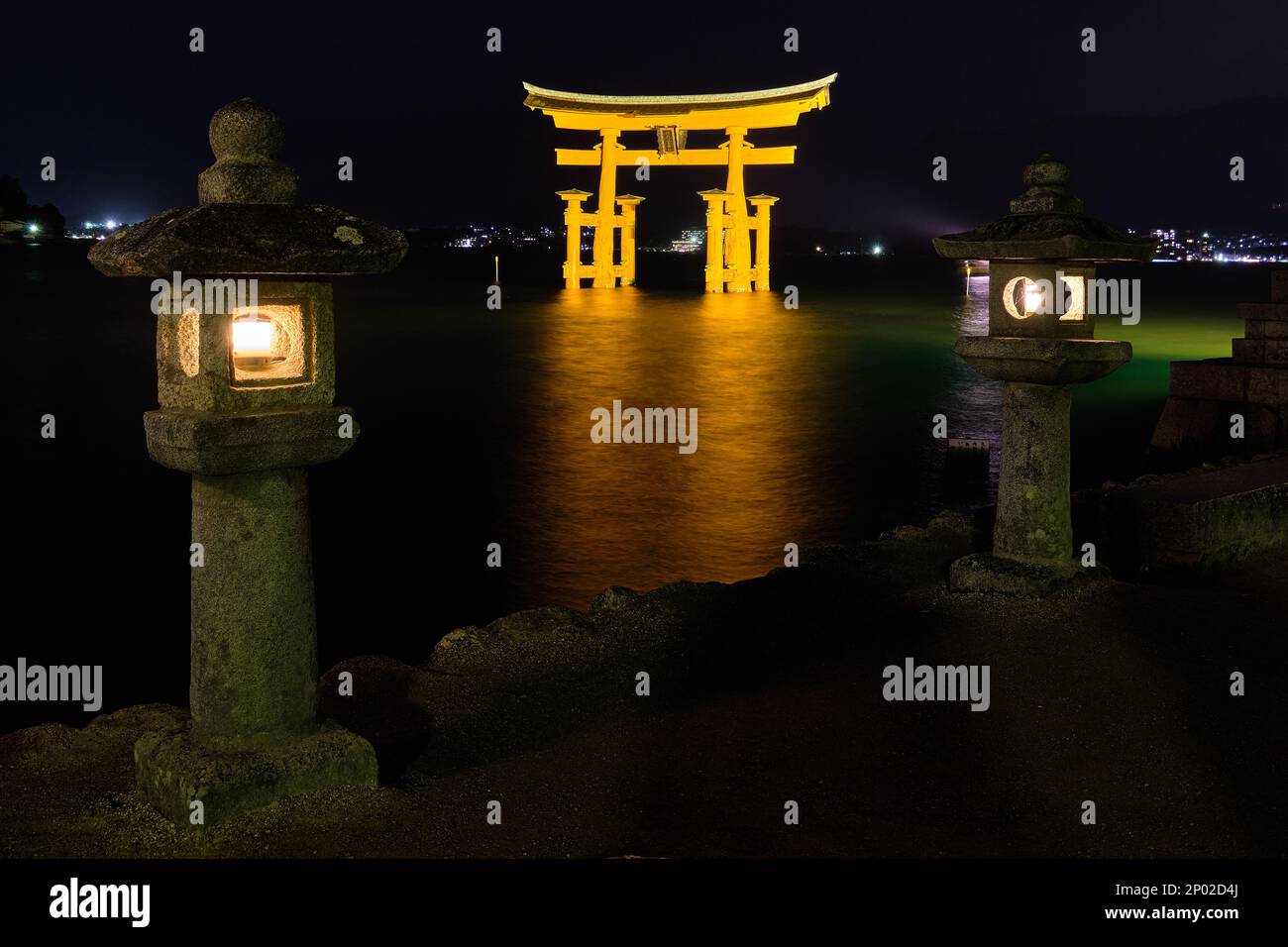 The famous Torii Gate at Miyajima Island illuminated at night with lit ...