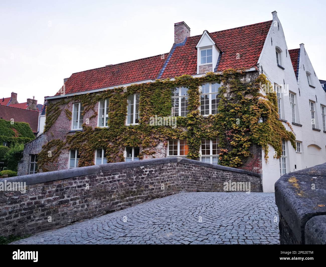 Classic cobblestoned bridge footpath leading towards traditional ...