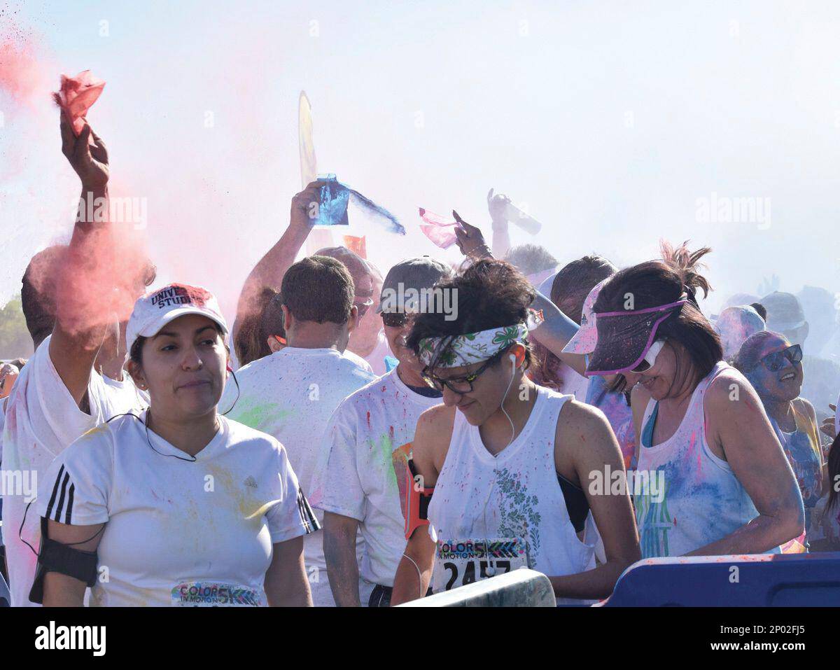 Participants of the Color in Motion 5K splash color on each other ...