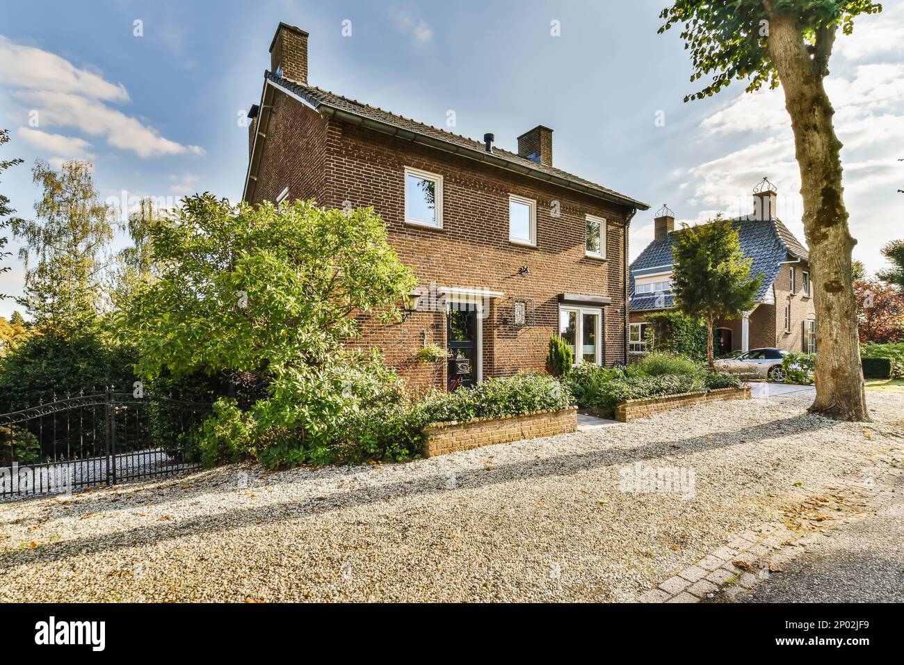 a brick house in the middle of an english country garden with trees and ...