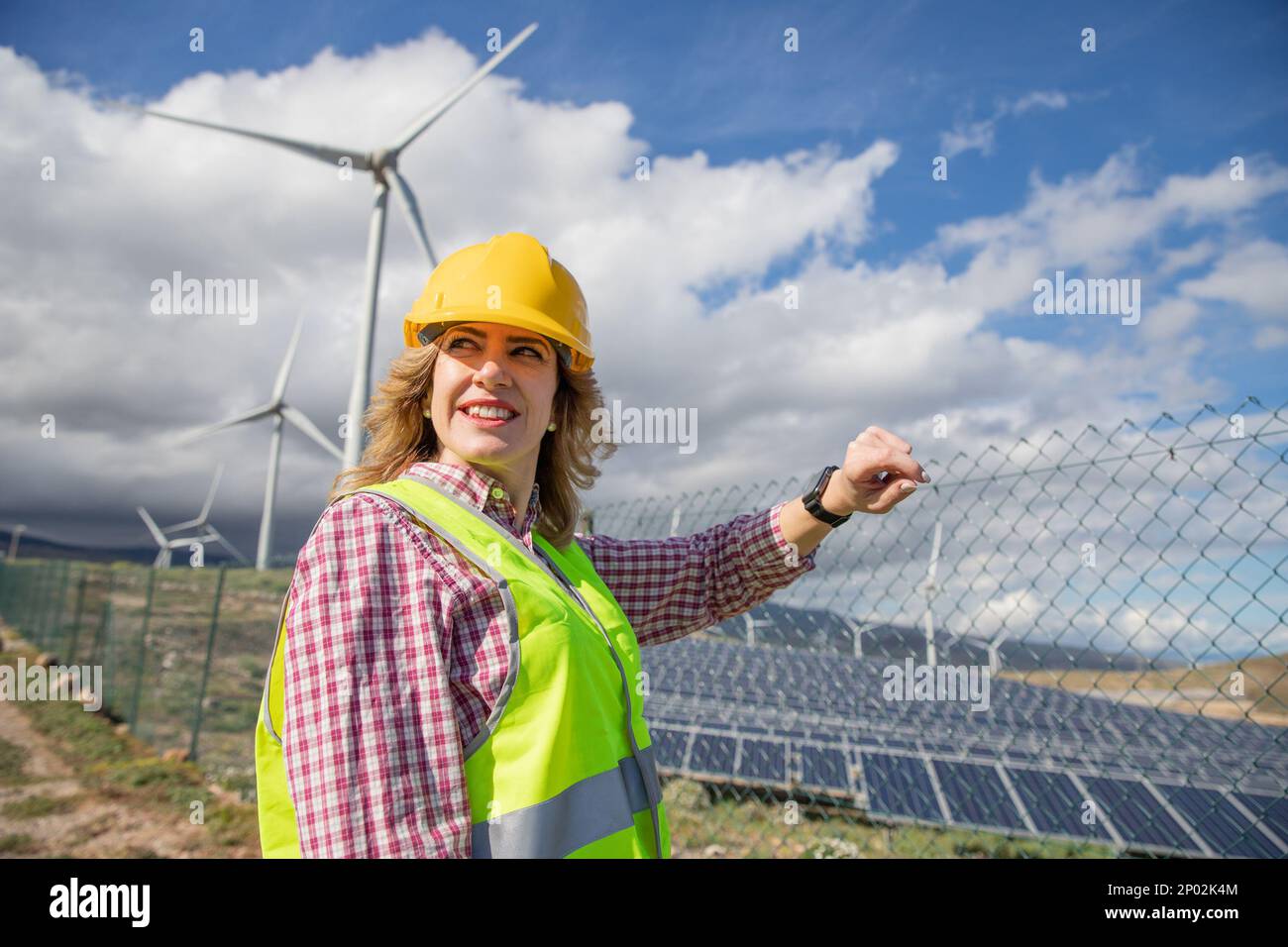 An engineer checks her smart watch while at the solar power plant Stock ...