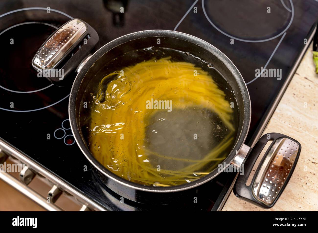 Cooking delicious spaghetti in boiling water Stock Photo - Alamy