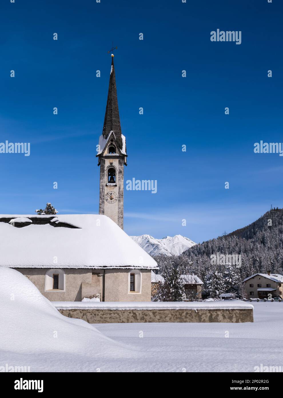 Reformed church in the snowy village of Cinuos Chel in the Engadin ...
