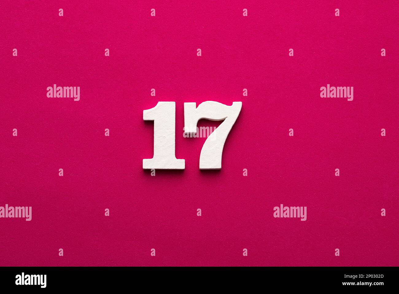 Number 17 - white number in wood on rhodamine red background Stock ...