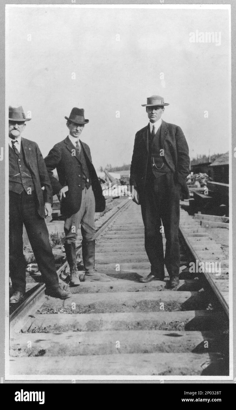 At the new railroad left to right are: Mr. Edes, Frank G. Carpenter ...
