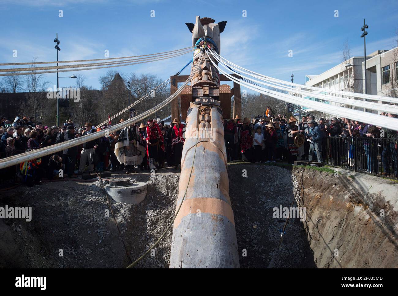 A blessing ceremony is performed before a Reconciliation Pole is raised ...