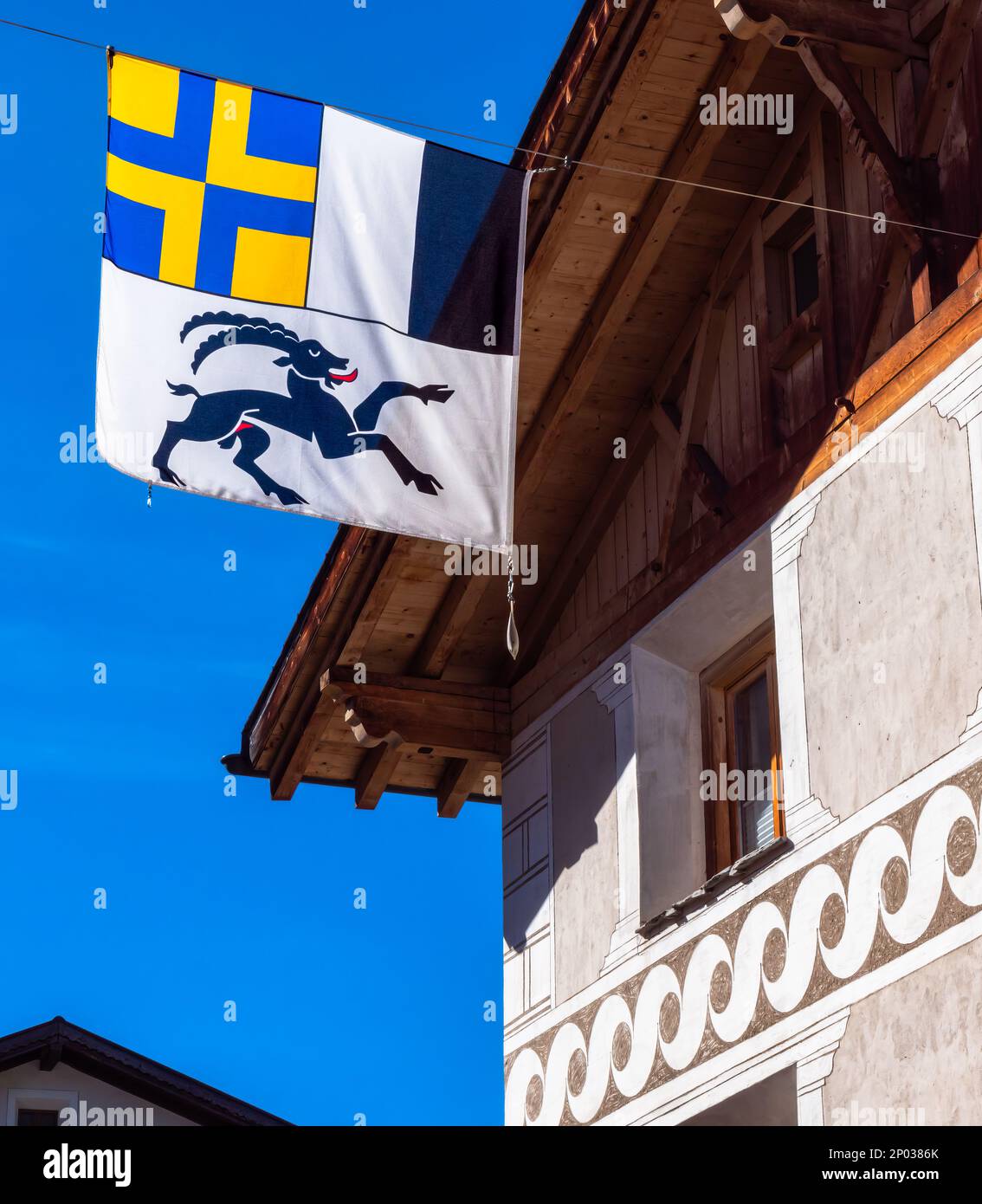 Traditional historical house in Mustair with the cantonal flag of the ...