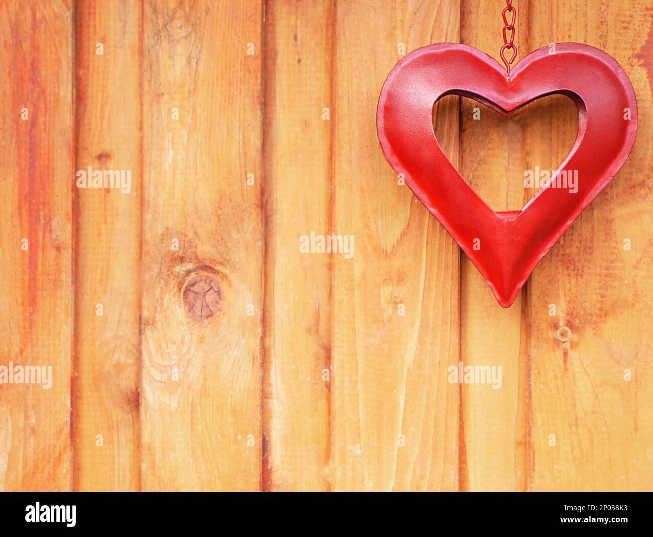 Red heart right on the bright brown wood wall. Valentines day ...