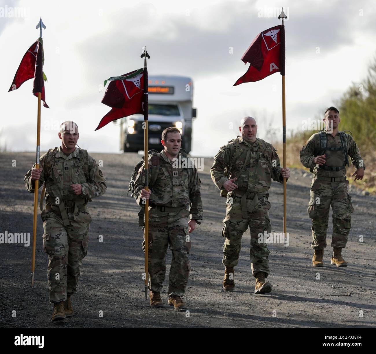 U.S. Soldiers assigned to Madigan Army Medical Center cross the finish ...