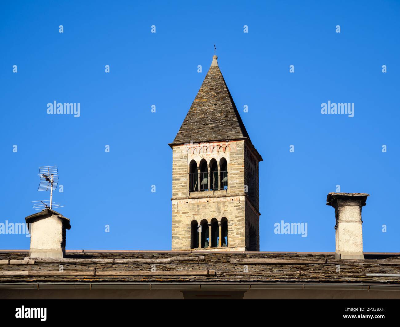 Church bell tower and the chimneys of the old town of Poschiavo ...