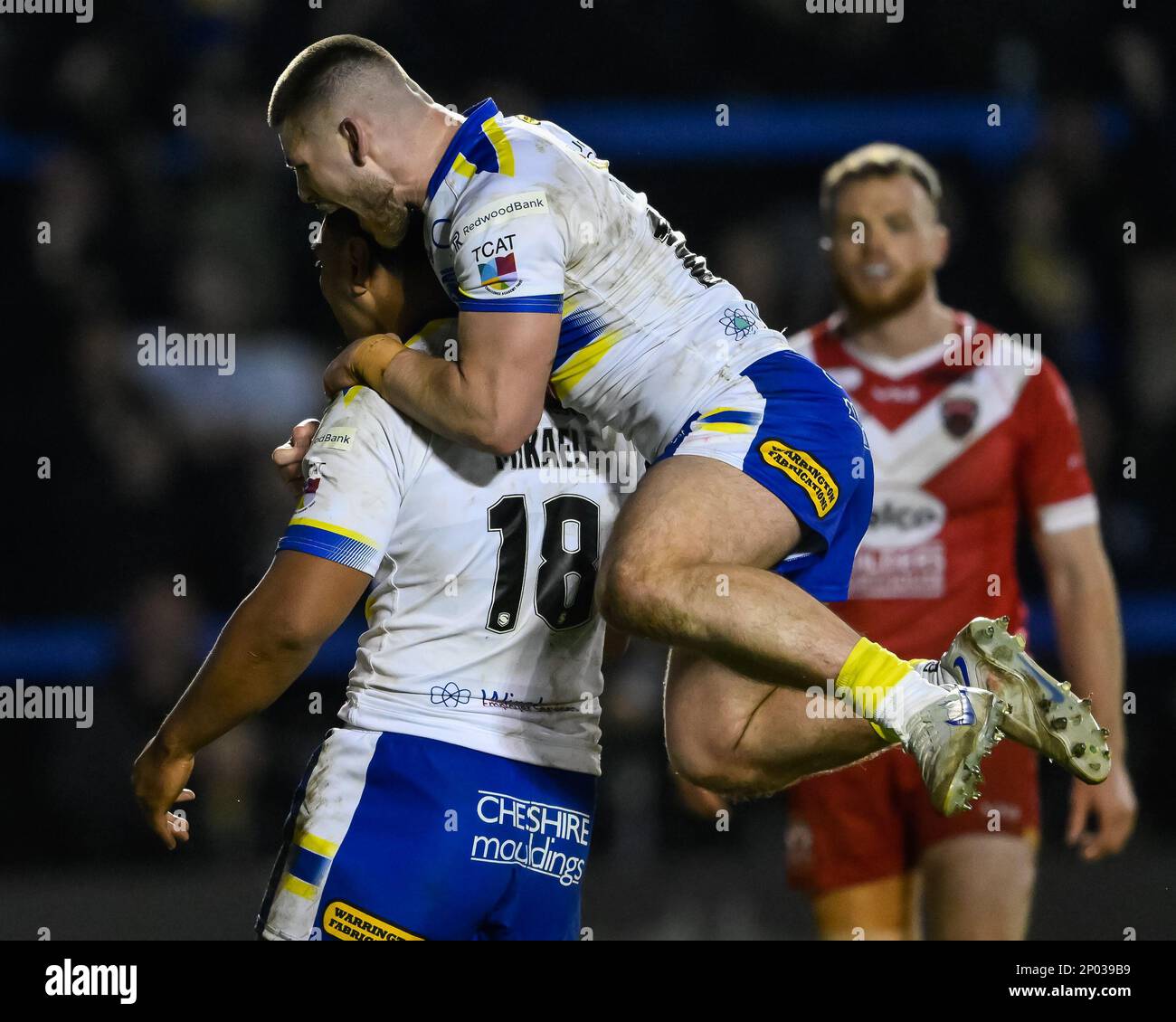Tom Mikaele #18 of Warrington Wolves celebrates his try during the ...