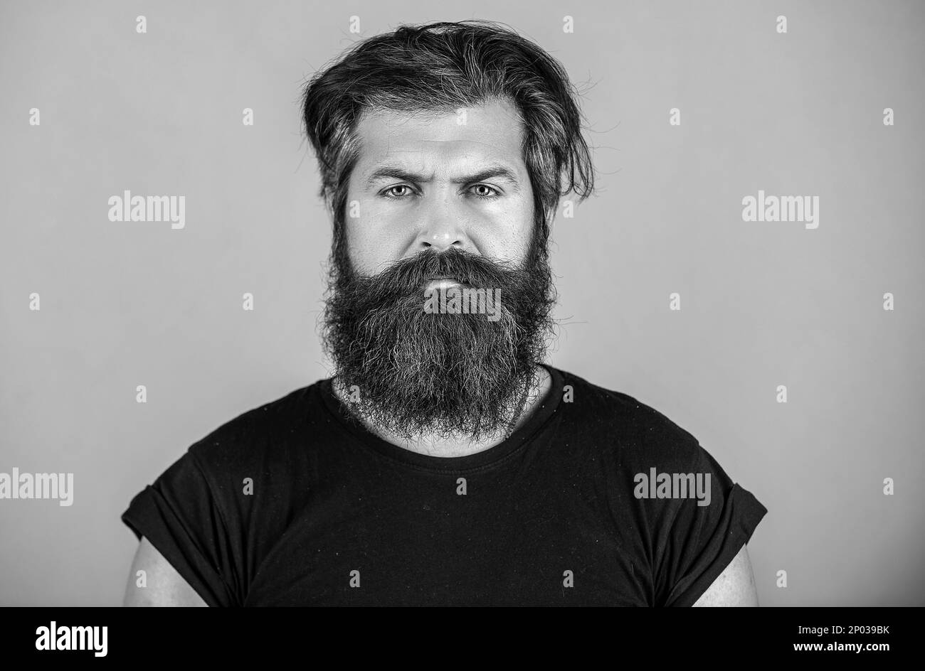 Long beard. Perfect beard. Close-up of young bearded man standing ...