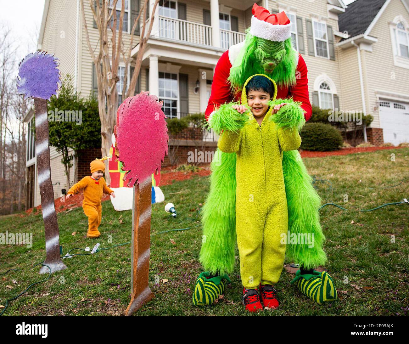 Liam Jackson, 6, stands with the Grinch amidst the Whoville decorations ...