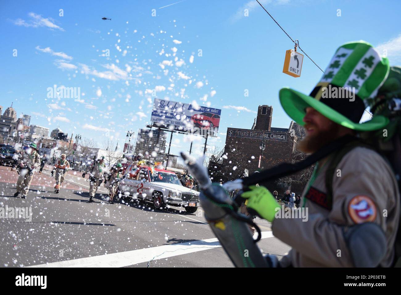 A group dressed up as the Ghostbusters spray the crowd gathered along ...