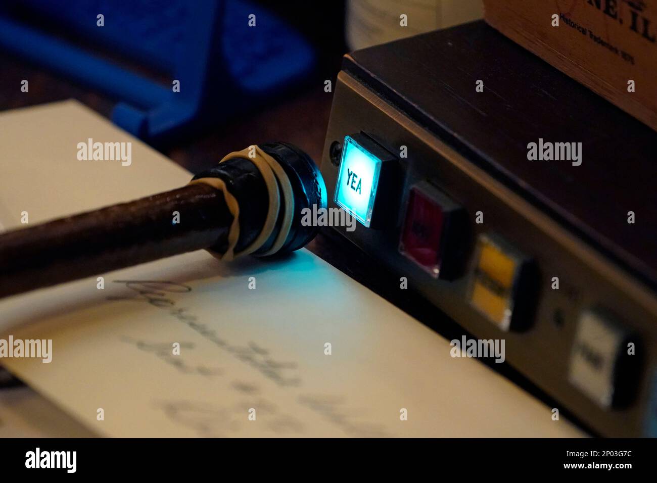 A House member takes advantage of his "voting stick" to press the "yea ...