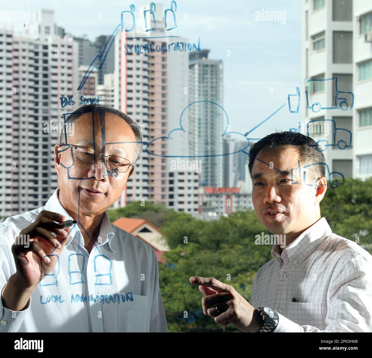 Mr Edwin Seah (right), CEO of Enhanzcom, whose company helps SMEs ...