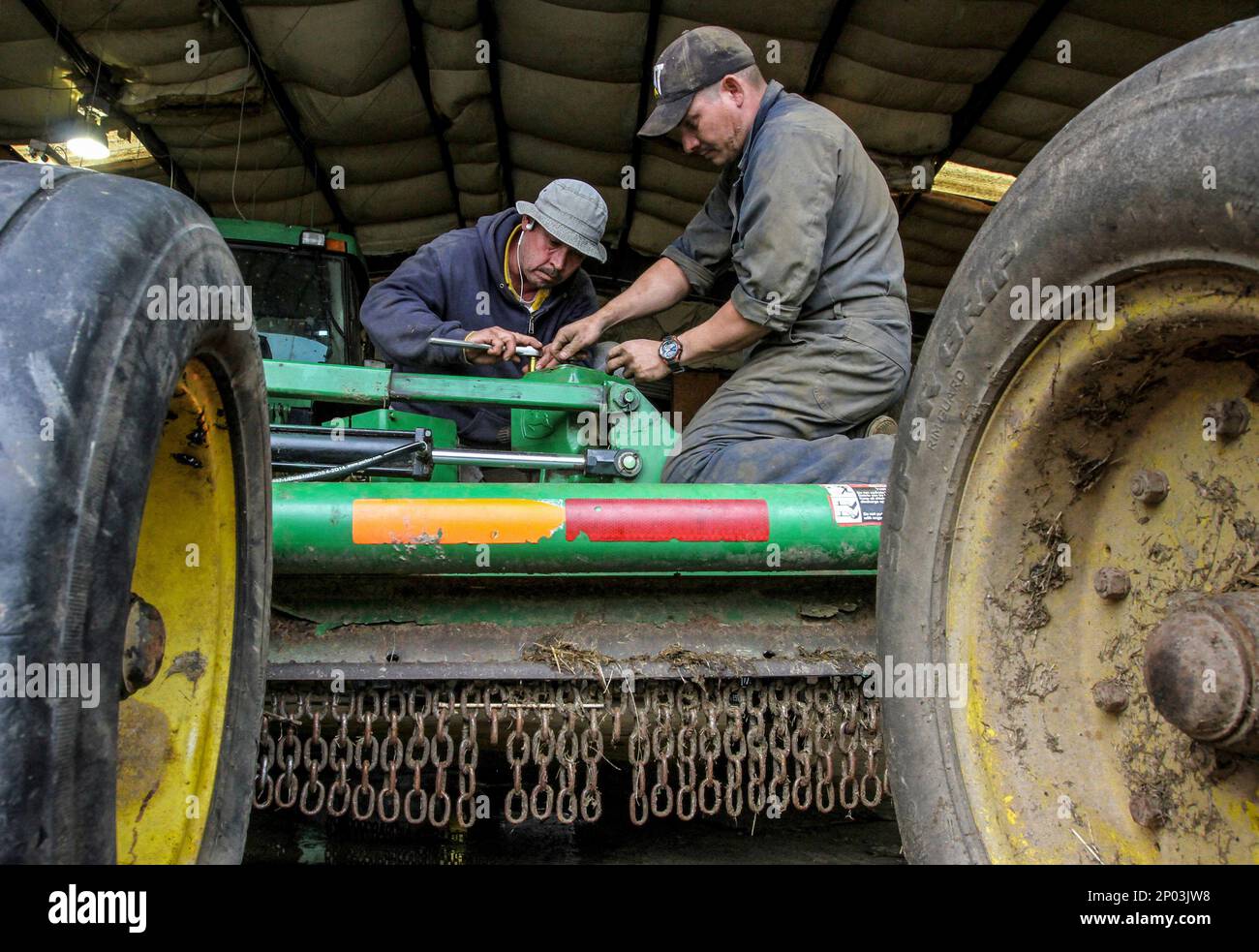 Armando Olague. left, and Axel Gomez Castello work inside the shop at ...