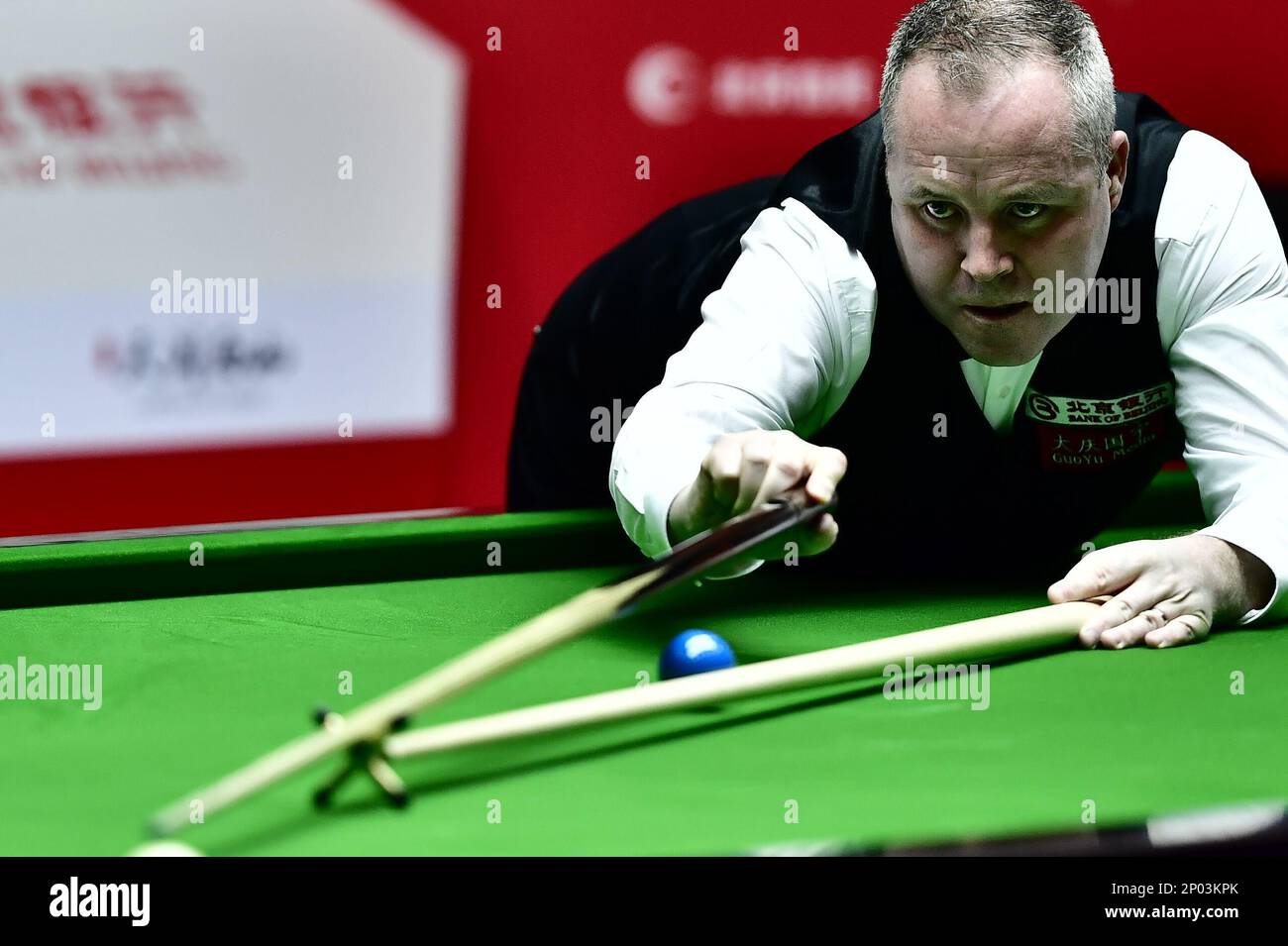 John Higgins of Scotland plays a shot to Ian Burns of England in their ...