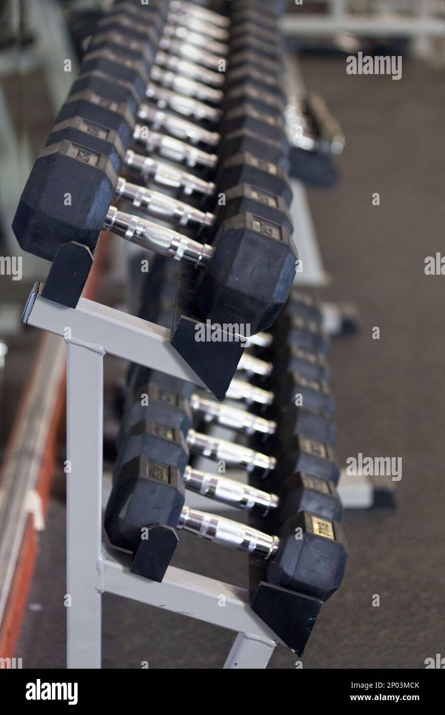 Set of dumbbells on a weight rack in a gym Stock Photo - Alamy