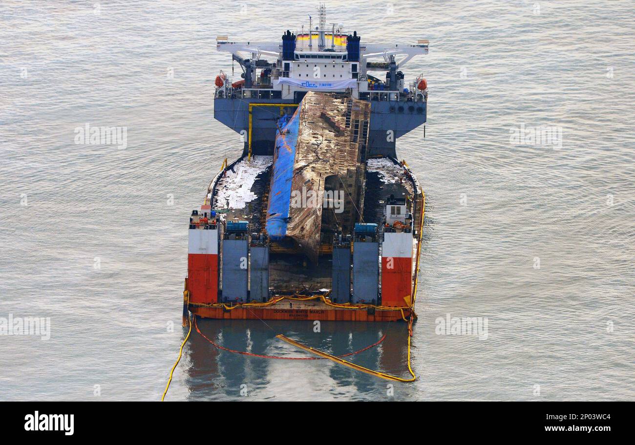 The sunken ferry Sewol is seen on a semi-submersible transport vessel ...