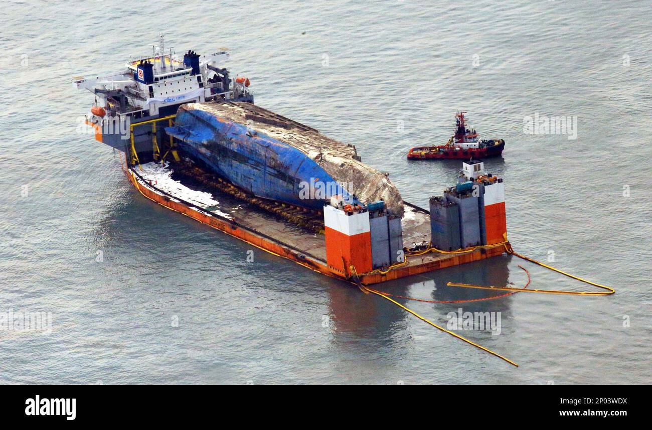 The sunken ferry Sewol is seen on a semi-submersible transport vessel ...