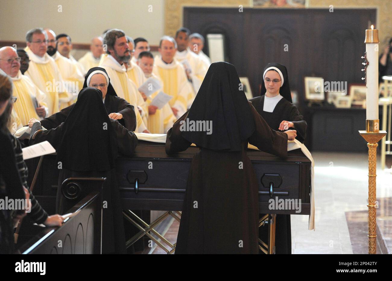 The Carmelite Sisters of the Divine Heart of Jesus place the pall over ...