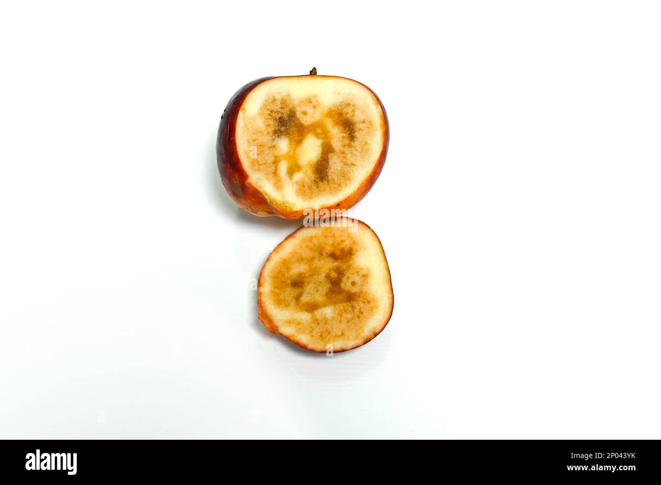 a rotten apple in the cut. on a white background Stock Photo - Alamy