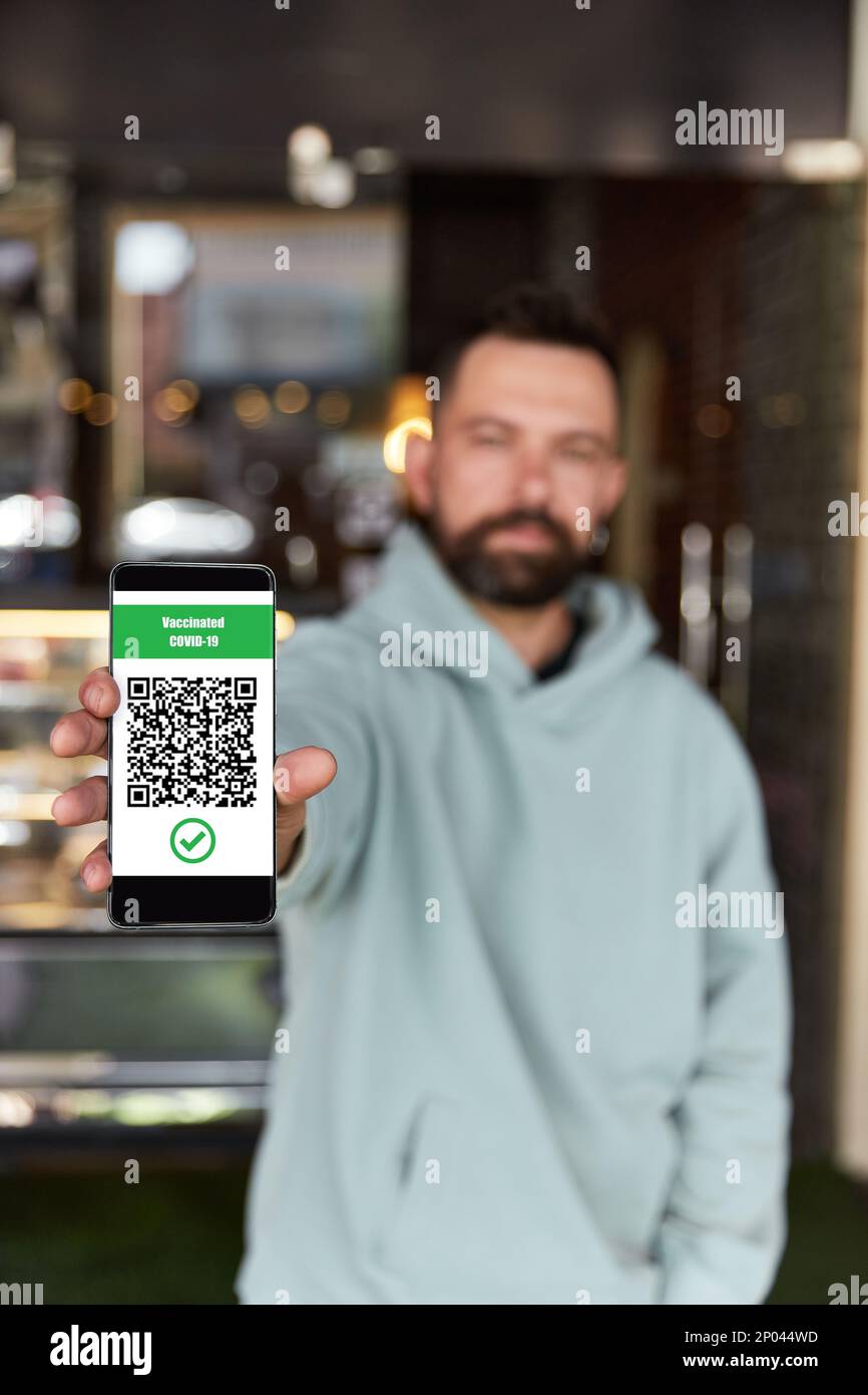 Man showing Qr Code on entrance to the restaurant. Digital vaccination ...