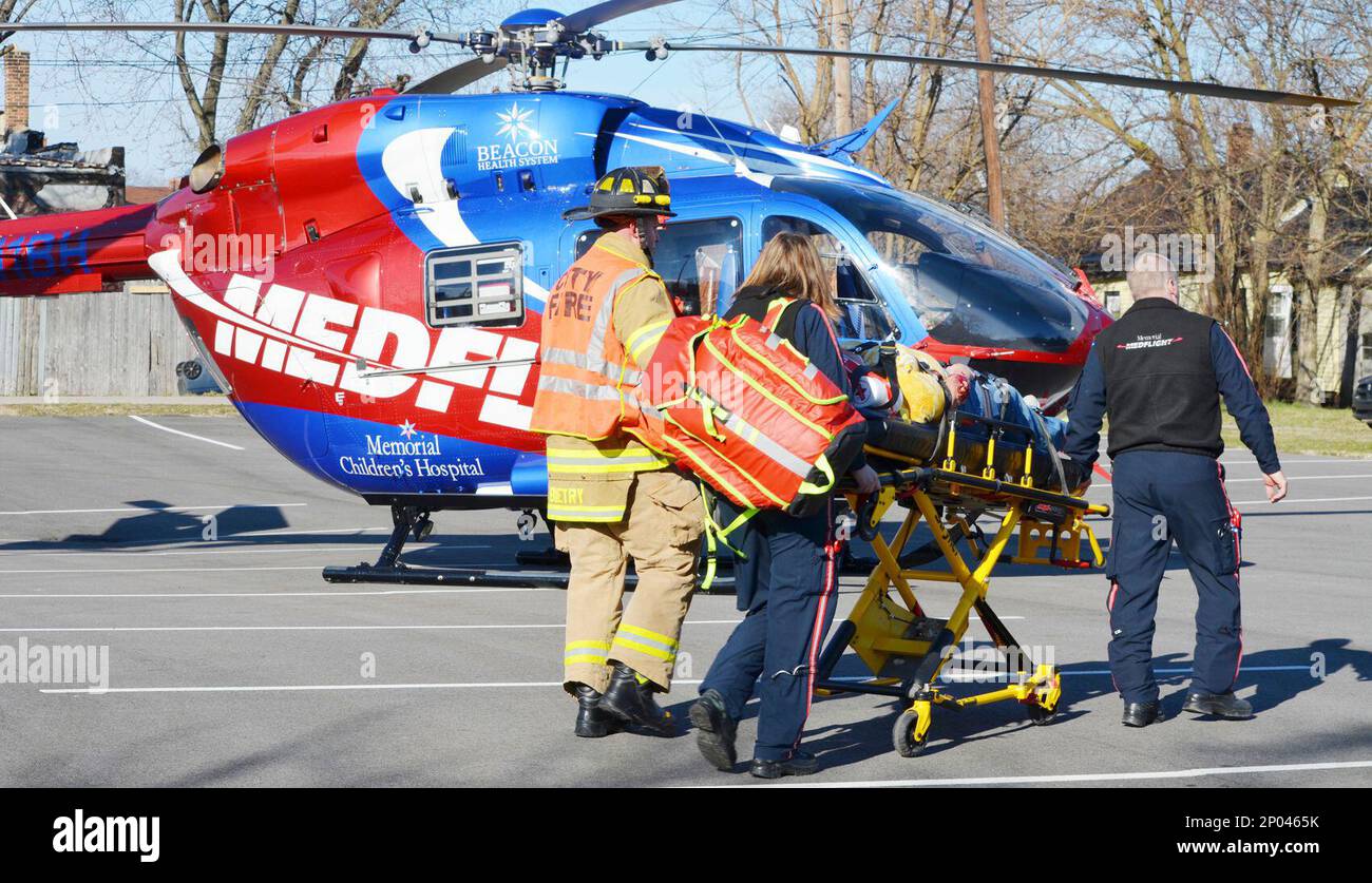 A student volunteer, portraying a crash victim, is carried off to a helicopter during a mock ...