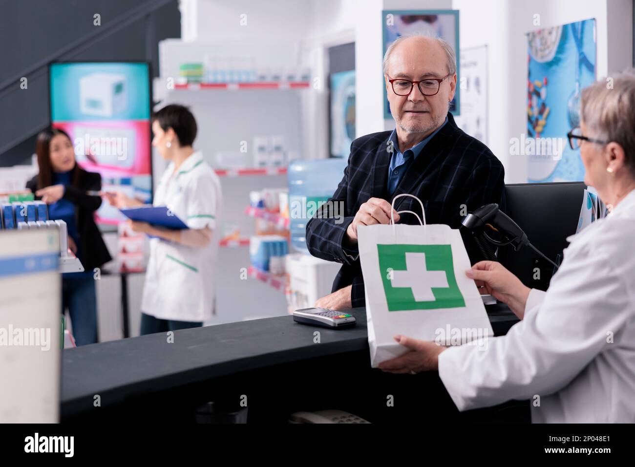 Senior man checking drugstore medications order in shopping bag at ...