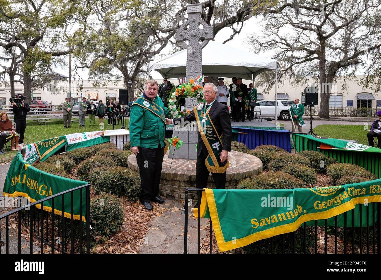 The Rev. Patrick O'Brien and Dennis Counihan place a wreath at the ...