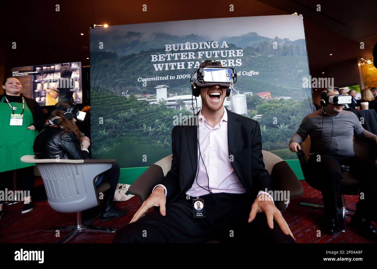 Starbucks employee Ed Devlin reacts as he views a 360 video of a ...