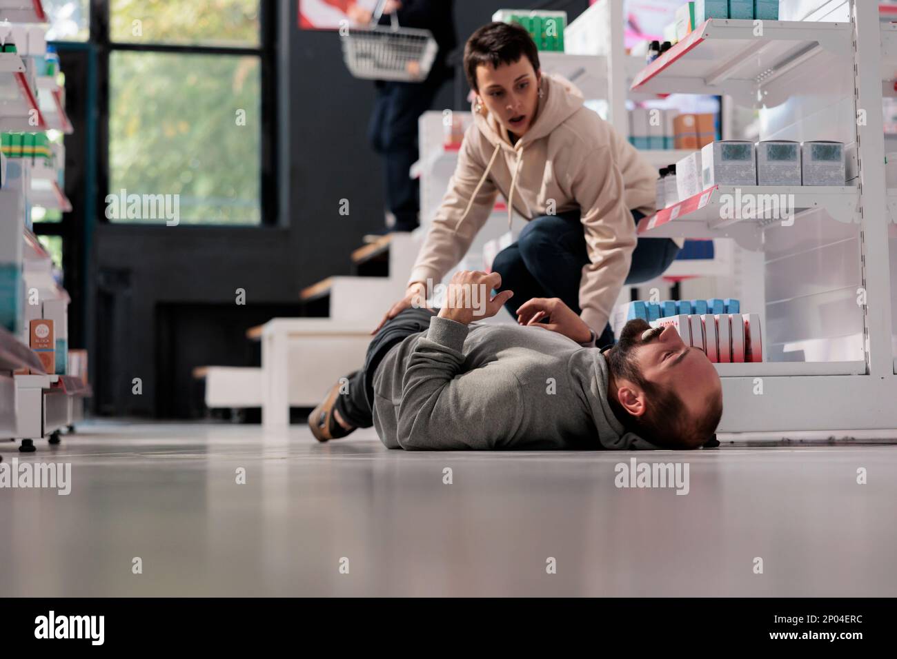 Woman running to man having seizure in medical retail store. Pharmacy ...