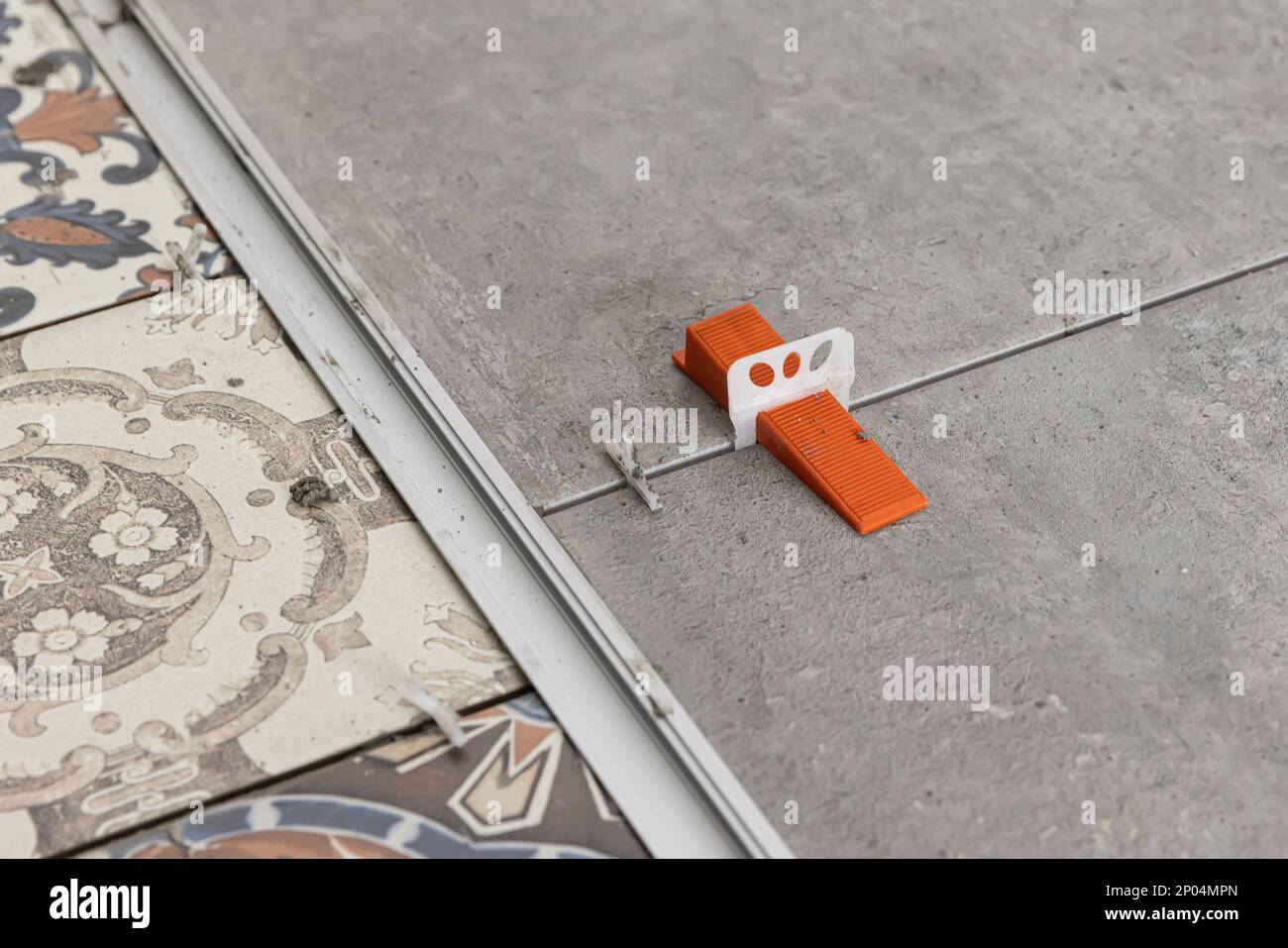 industrial ceramic builder worker installing floor tile at repair ...