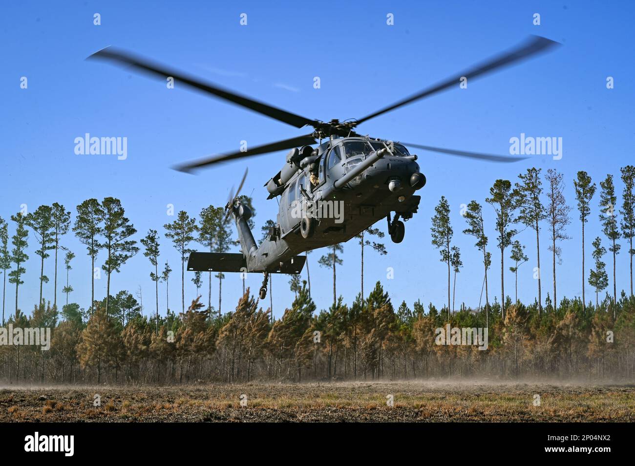 A 920th Rescue Wing HH-60G Pave Hawk helicopter lands in a field at ...