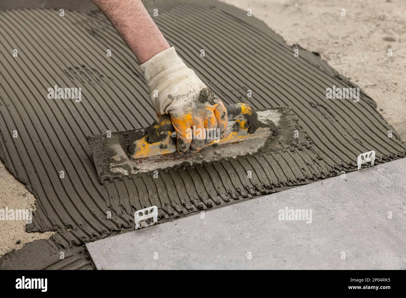 industrial ceramic builder worker installing floor tile at repair ...