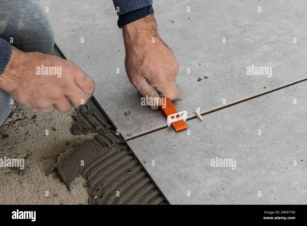 industrial ceramic builder worker installing floor tile at repair ...