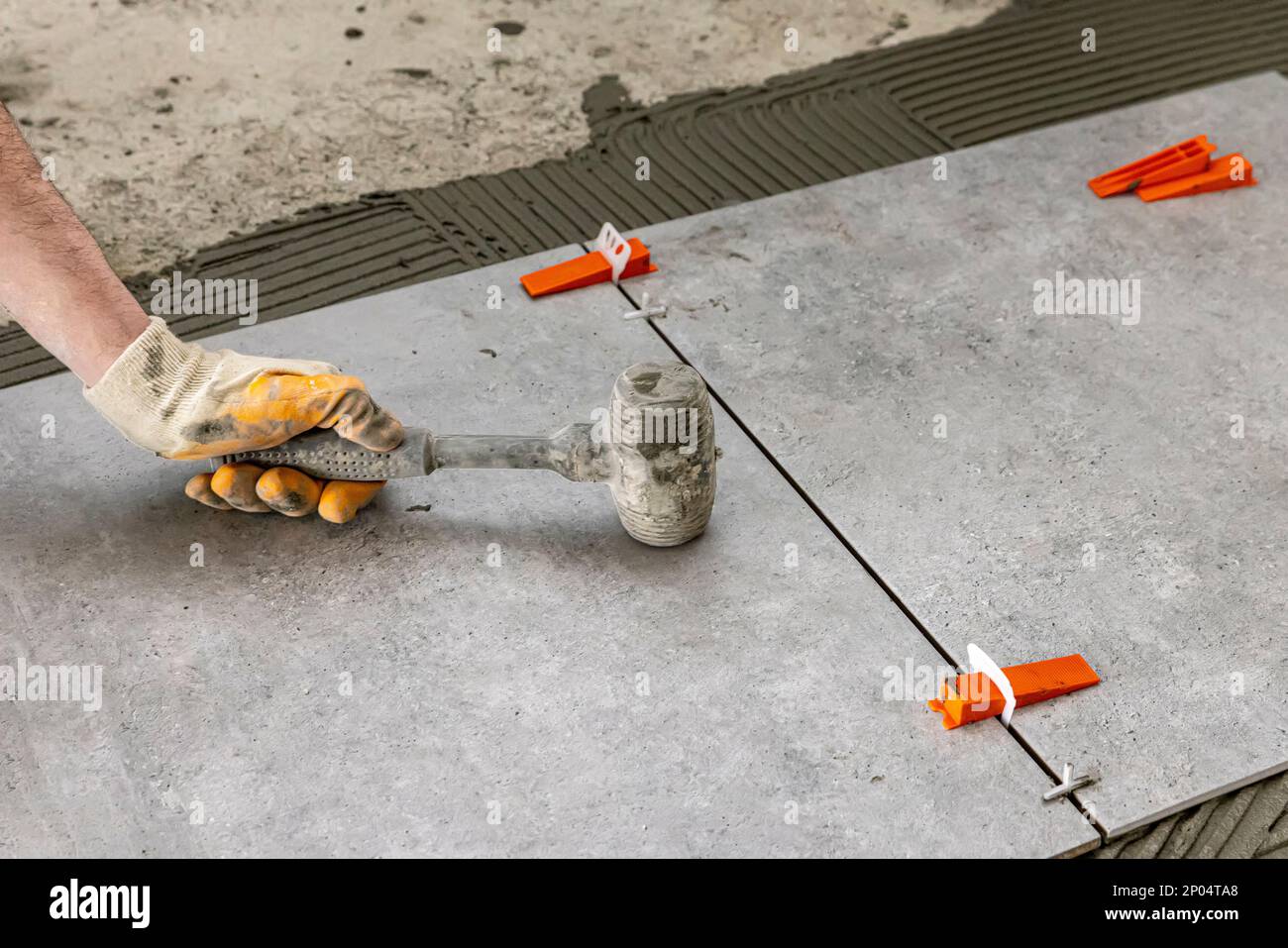 industrial ceramic builder worker installing floor tile at repair ...