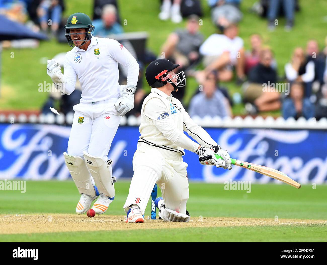 South Africa's Quentin de Kock, left, celebrates as New Zealand's Henry ...
