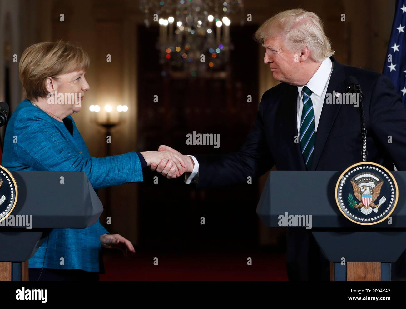 President Donald Trump and German Chancellor Angela Merkel shake hands ...