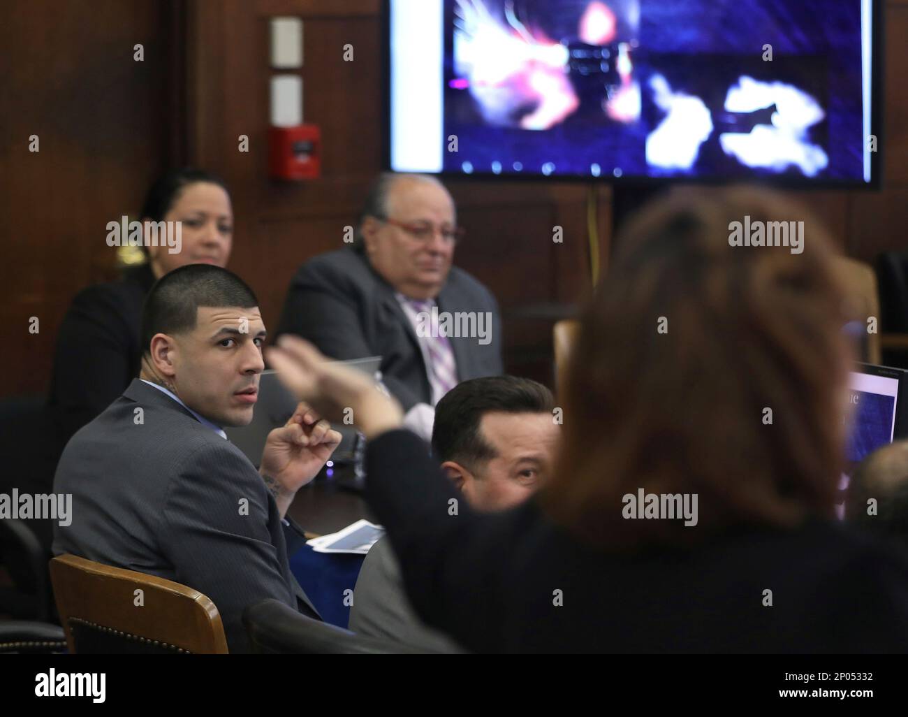 Former New England Patriots tight end Aaron Hernandez listens as ...