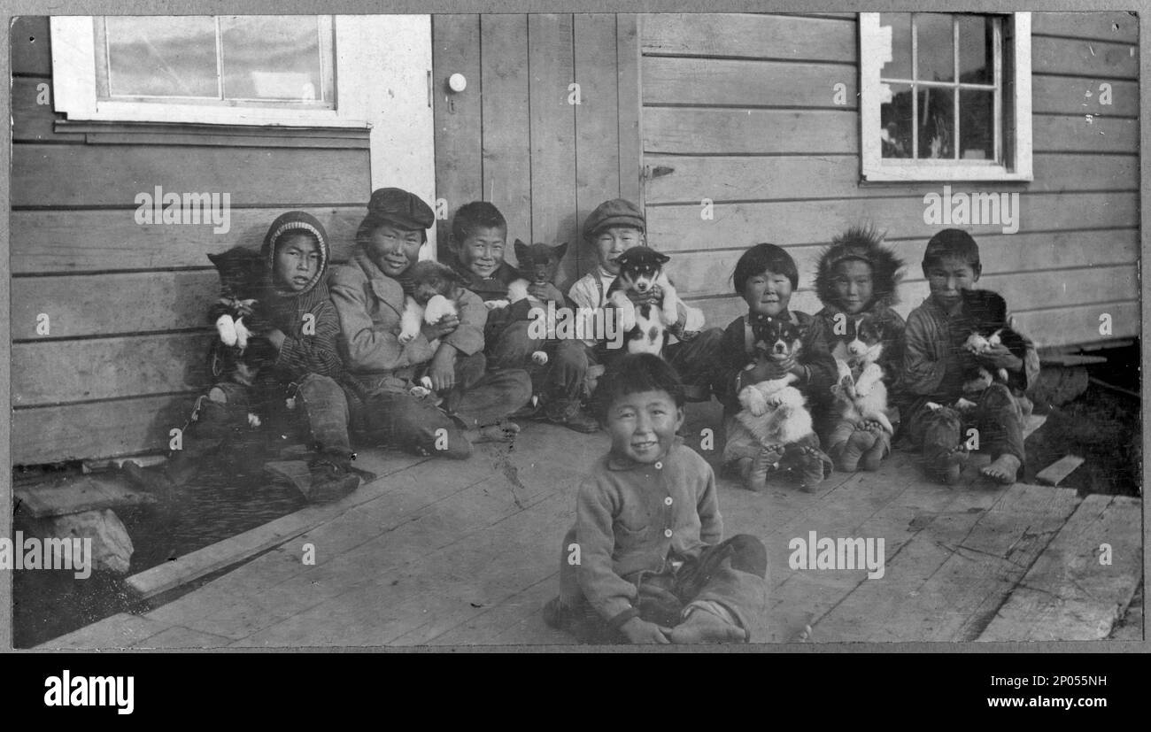 Eskimo children and puppies at the Moravian Mission Station. Frank and ...