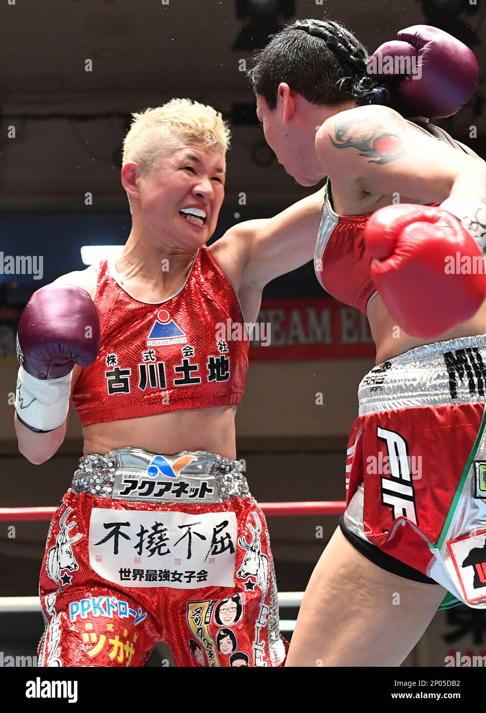 Japan's Naoko Fujioka (L) lands a punch against Mexico's Isabel Millan ...