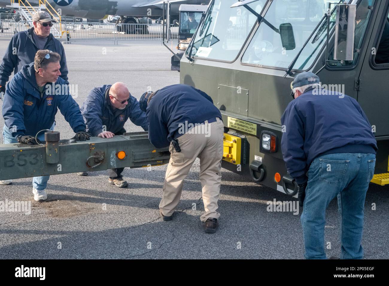 Air Mobility Command Museum staff adjust the tow bar attached to a ...