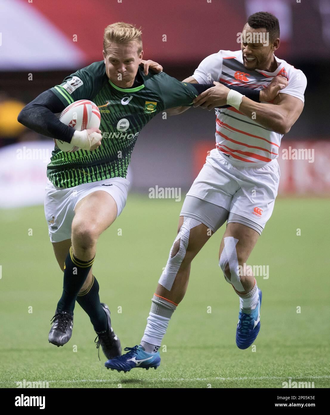 South Africa's Dylan Sage, left, tries to fight off England's Dan ...